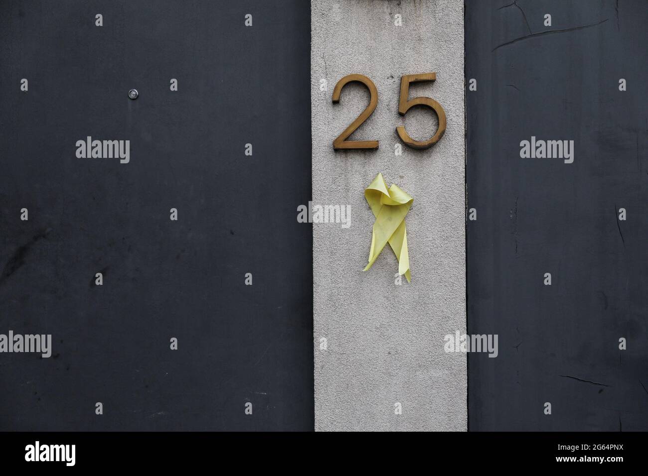 A yellow ribbon is placed outside the house of former Philippine ...