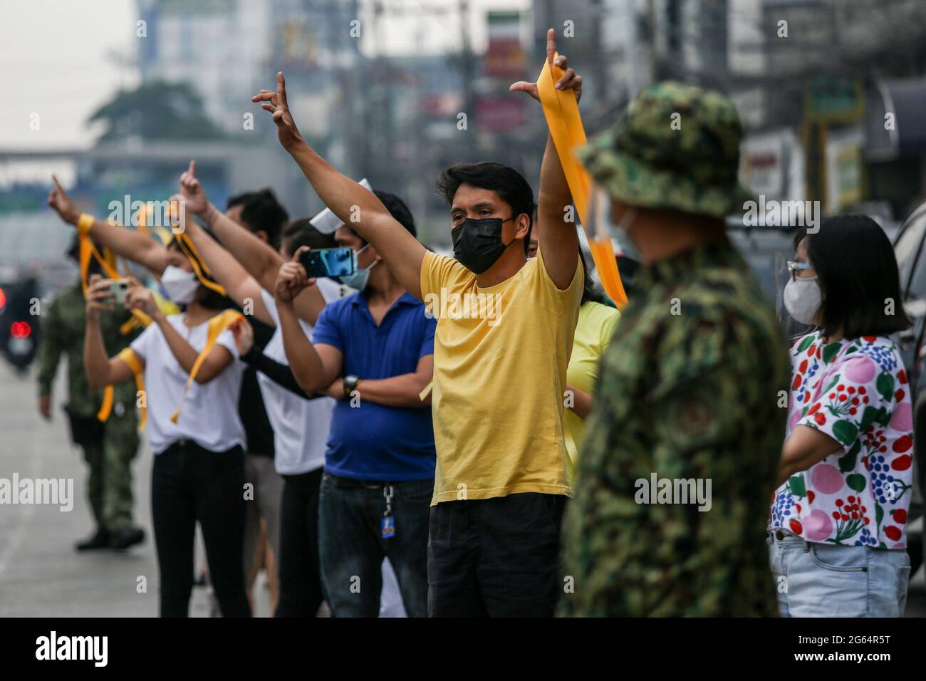 Supporters of former Philippine President Benigno Aquino III flash the ...