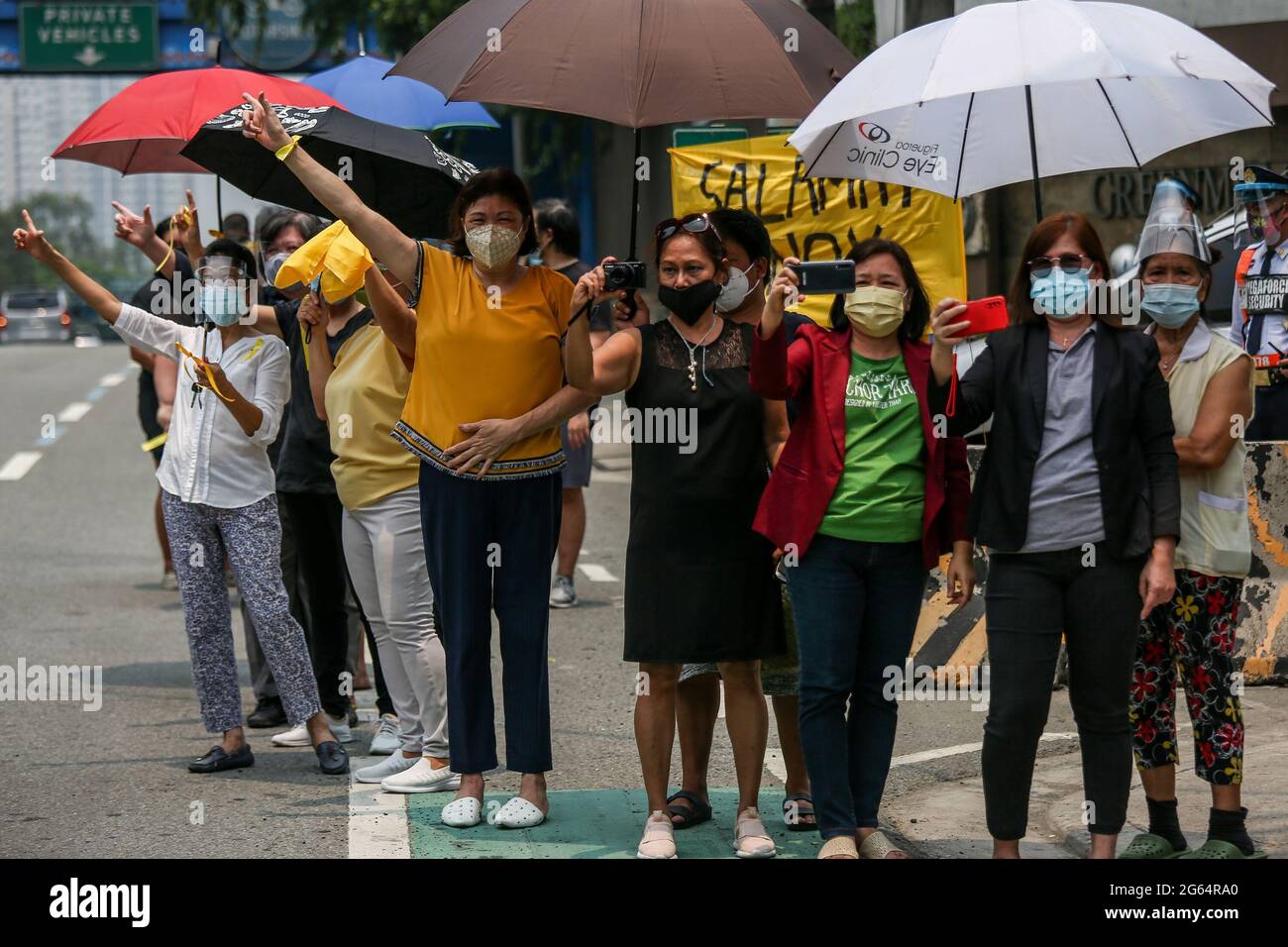 Supporters of former Philippine President Benigno Aquino III flash the ...