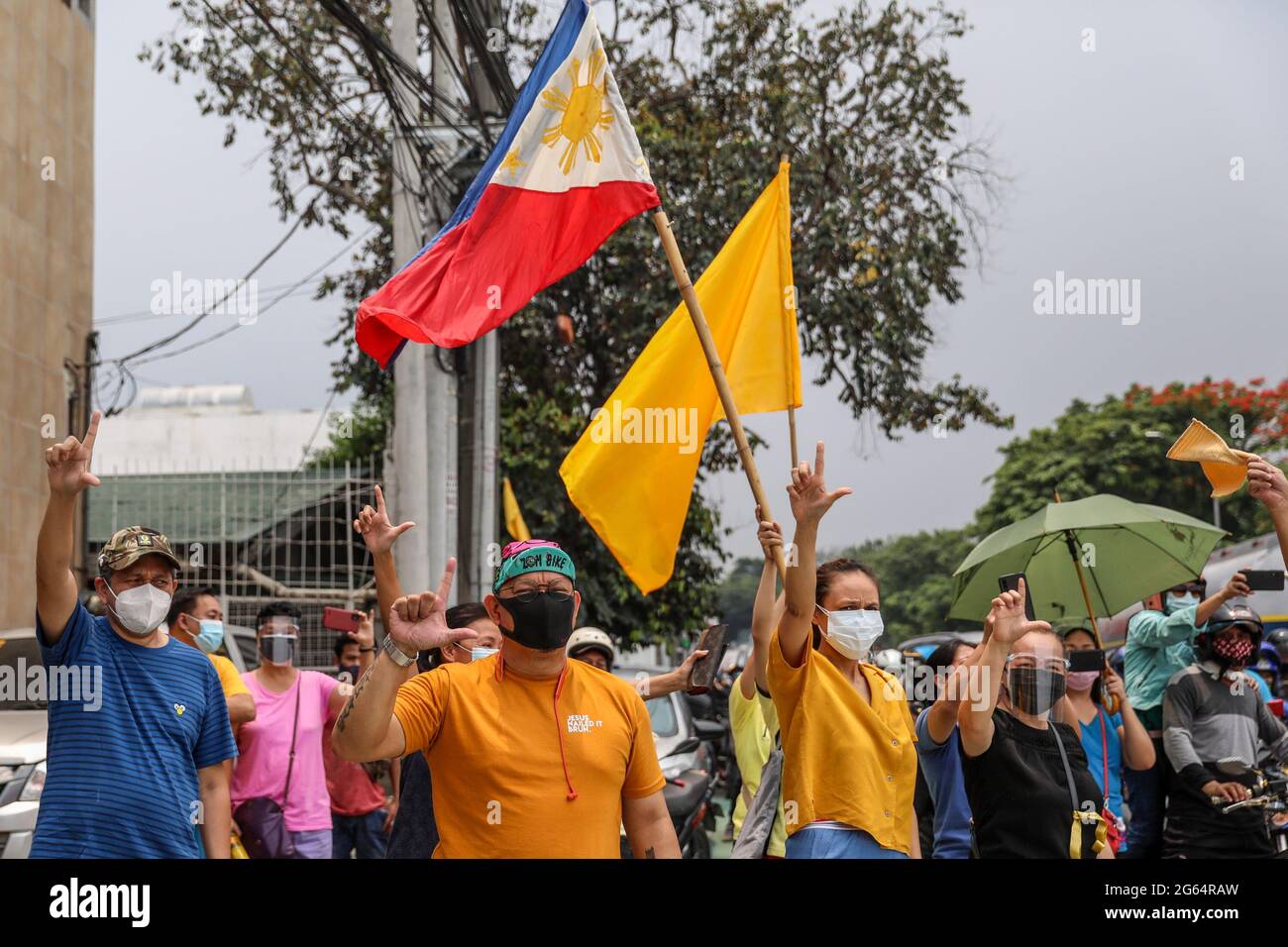 Supporters of former Philippine President Benigno Aquino III flash the ...