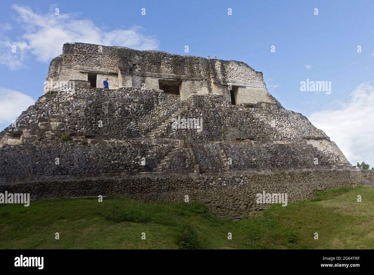 A person walks along the back side of "El Castillo Stock Photo - Alamy