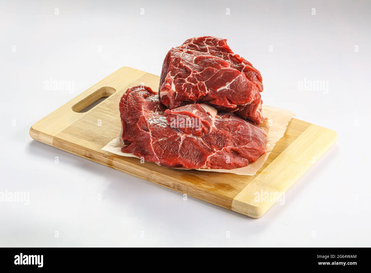 Raw beef neck over board isolated Stock Photo - Alamy