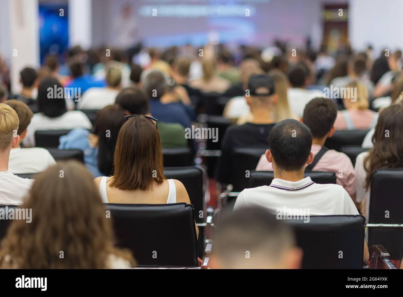 Speaker on the podium. People at conference hall, rear view Stock Photo ...