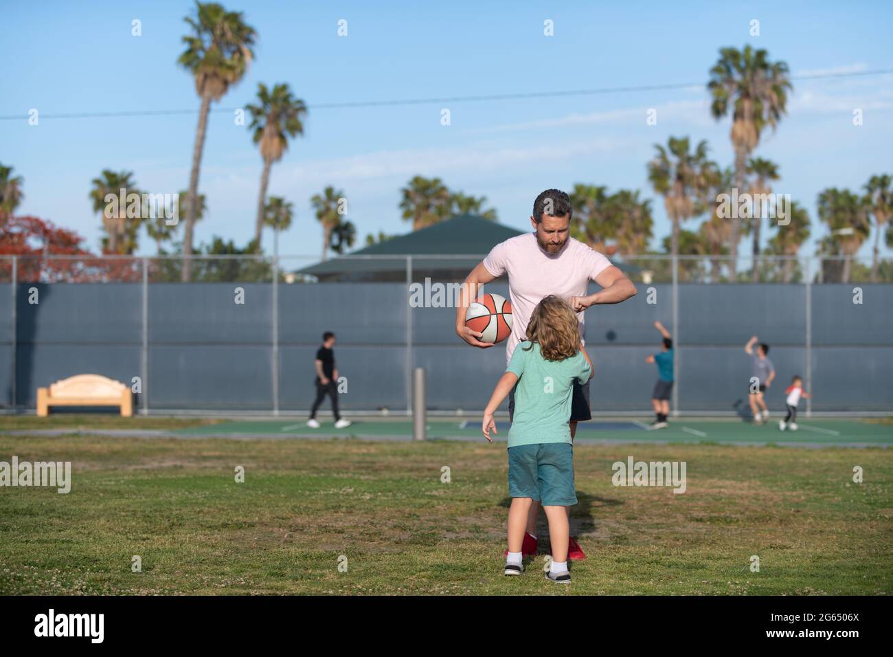 teacher and pupil play basketball in playground outdoor at school ...