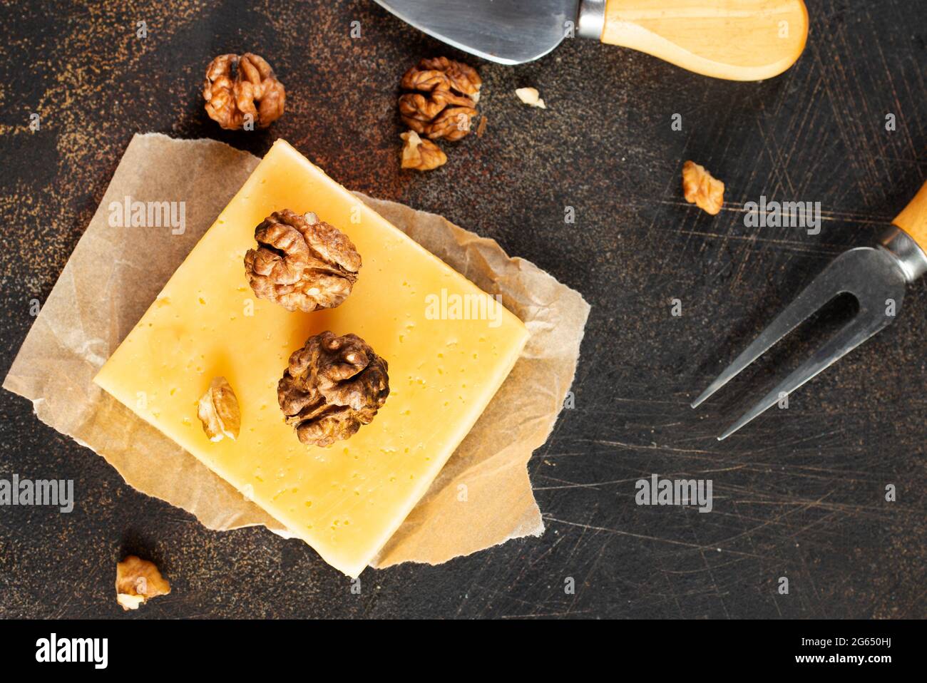 cheese with walnut, cheese on paper on a table Stock Photo - Alamy