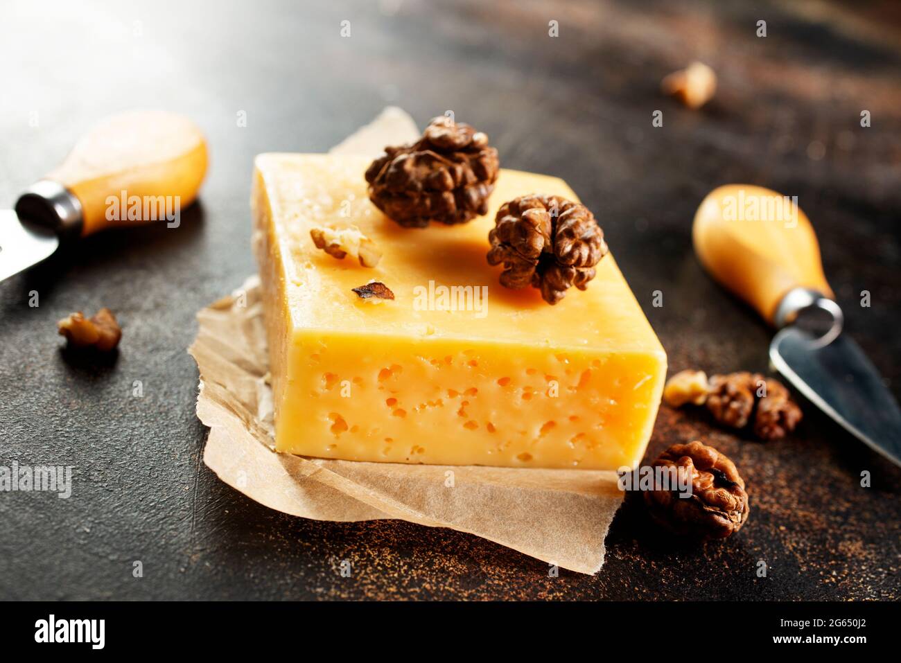 cheese with walnut, cheese on paper on a table Stock Photo - Alamy