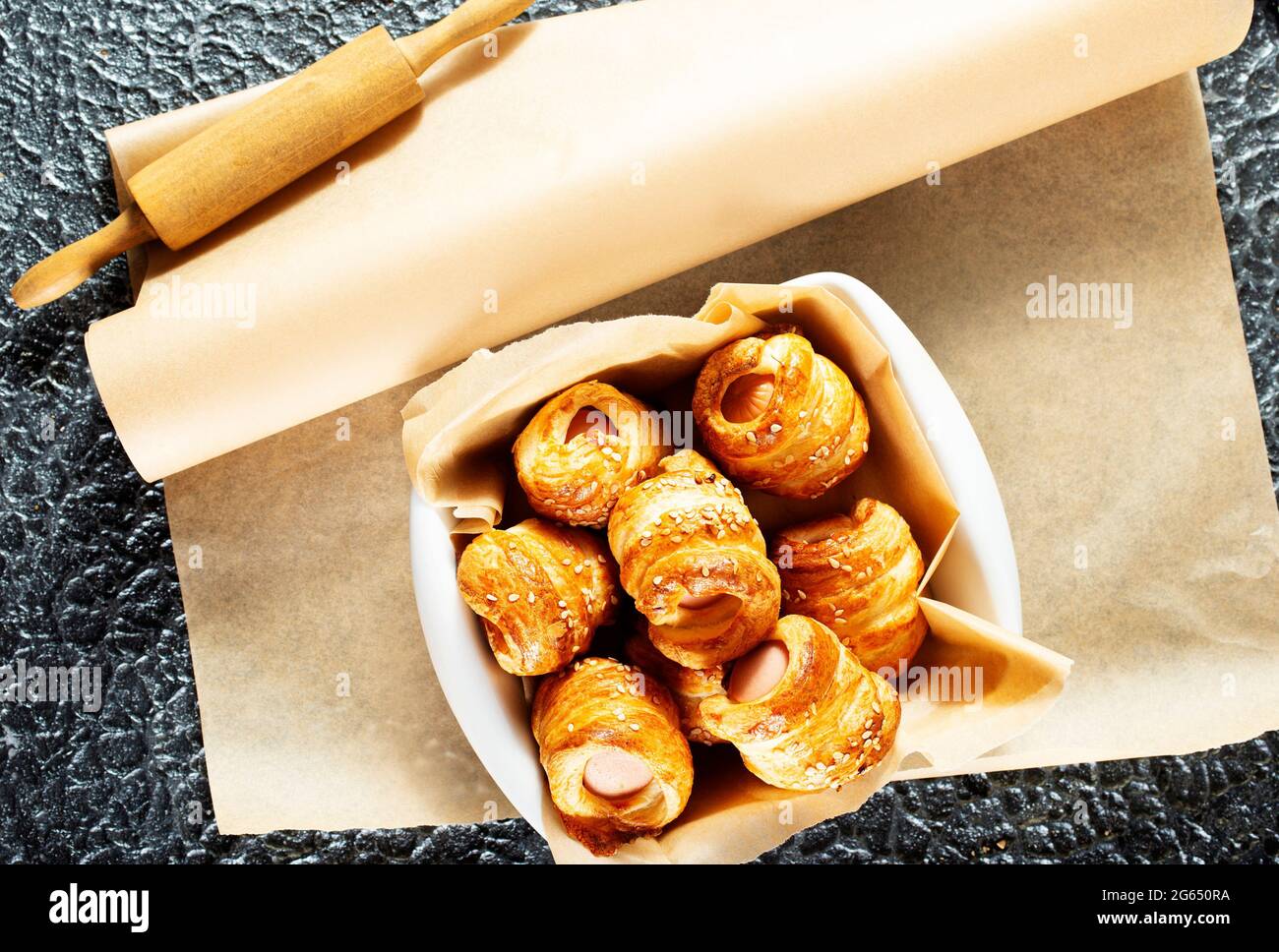 Crispy bread stuffed slice pork sausages on plate and on a paper Stock ...