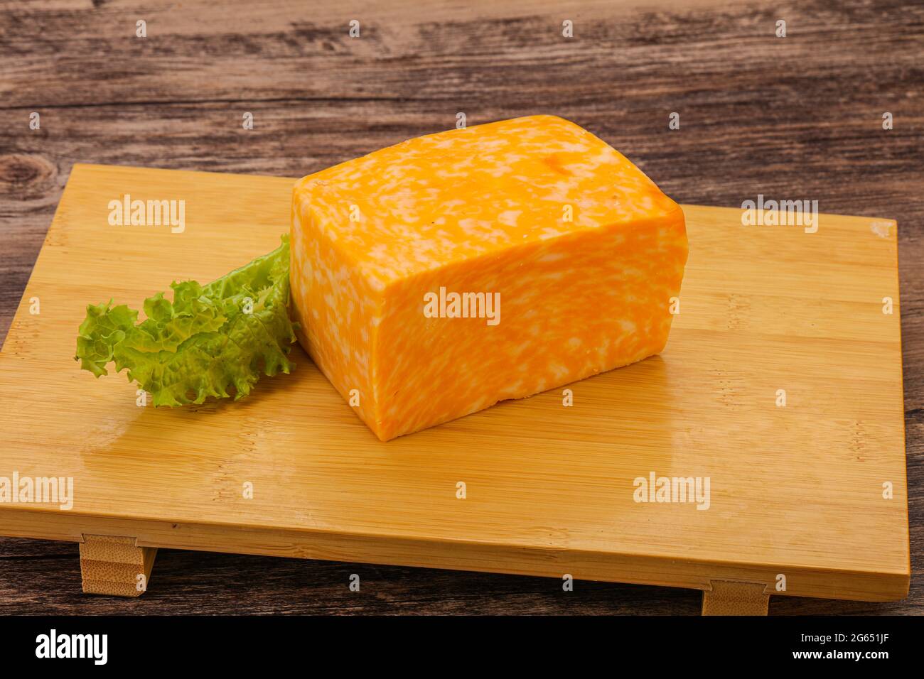 Dairy Marble cheese brick over board Stock Photo - Alamy