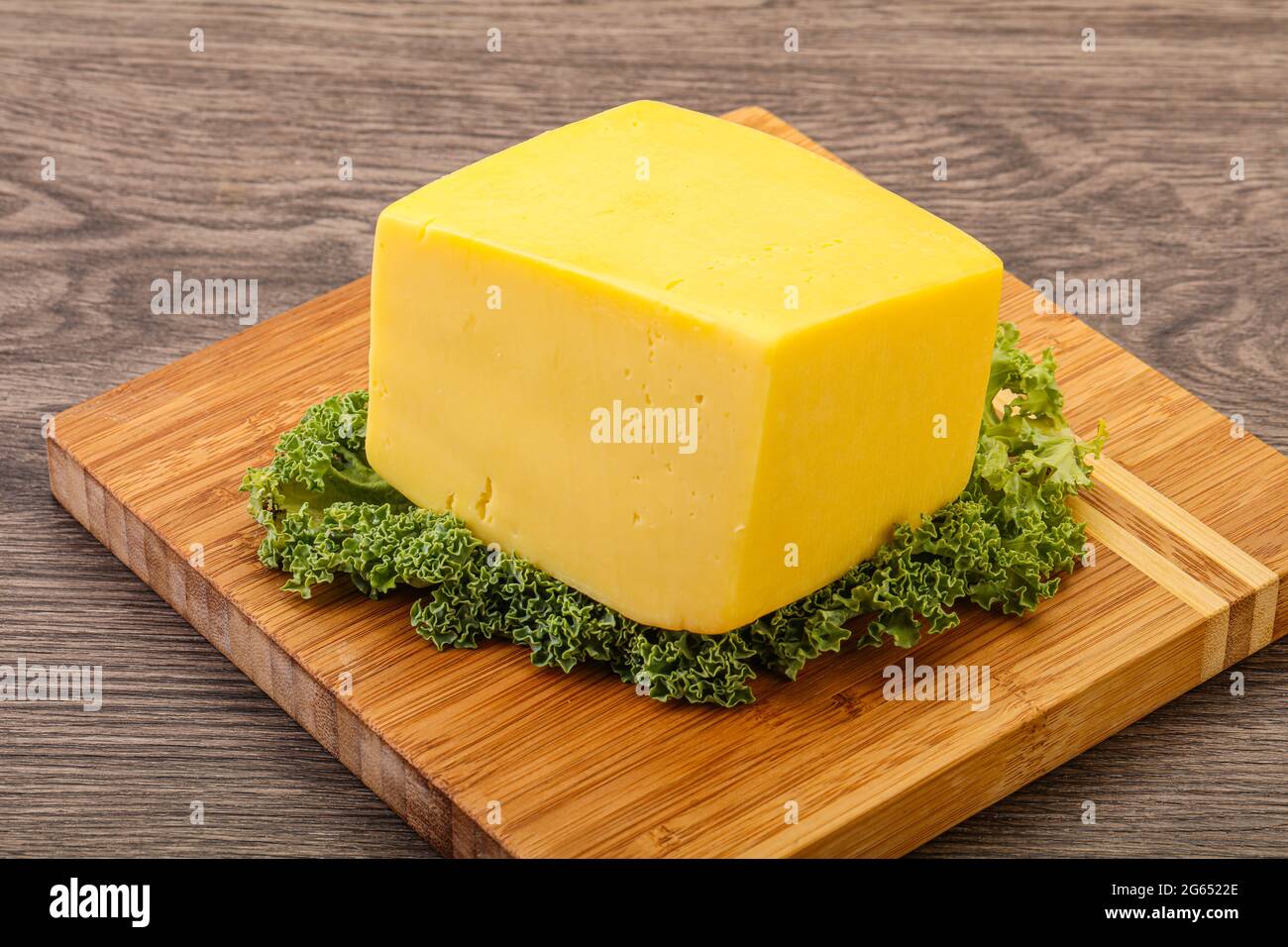 Yellow tilsiter cheese dairy product brick Stock Photo - Alamy