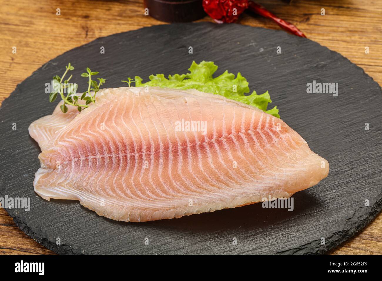 Raw tilapia fish fillet for cooking Stock Photo - Alamy