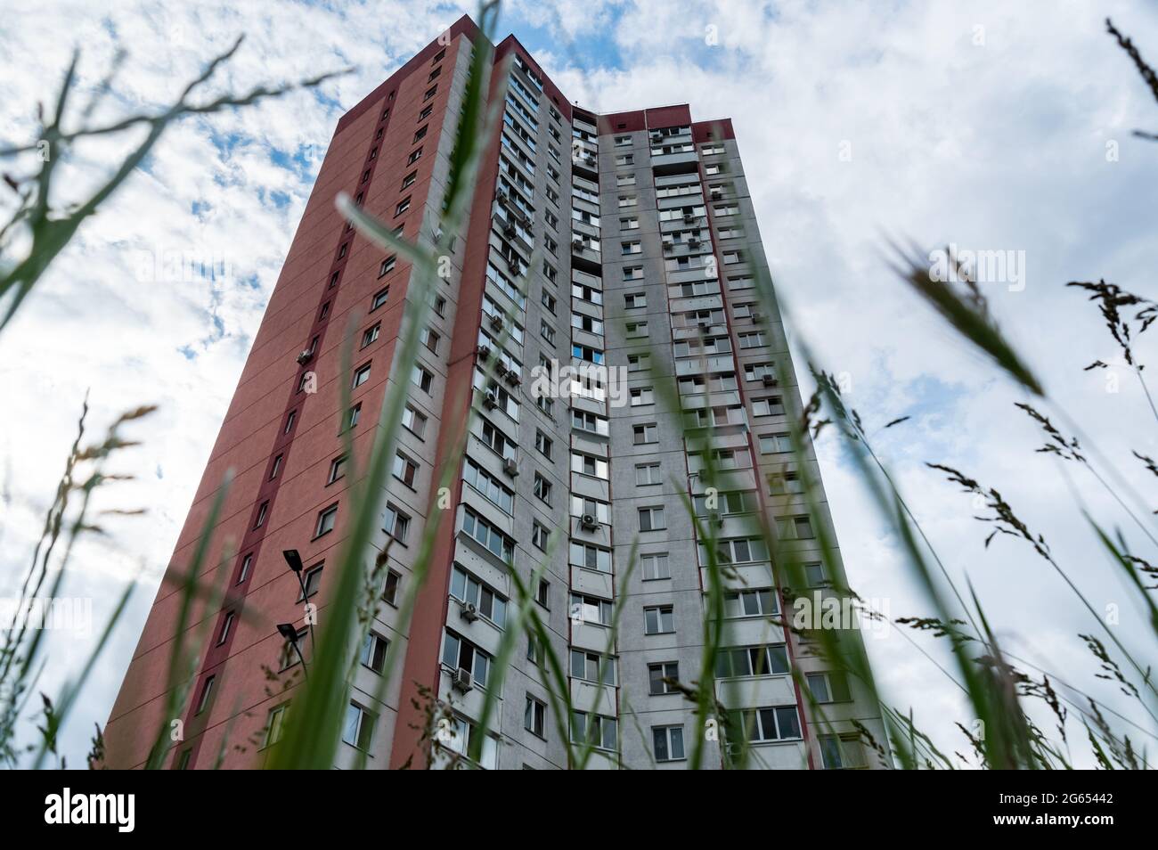 Large multi-storey building. Bottom view of the house. View of the top ...