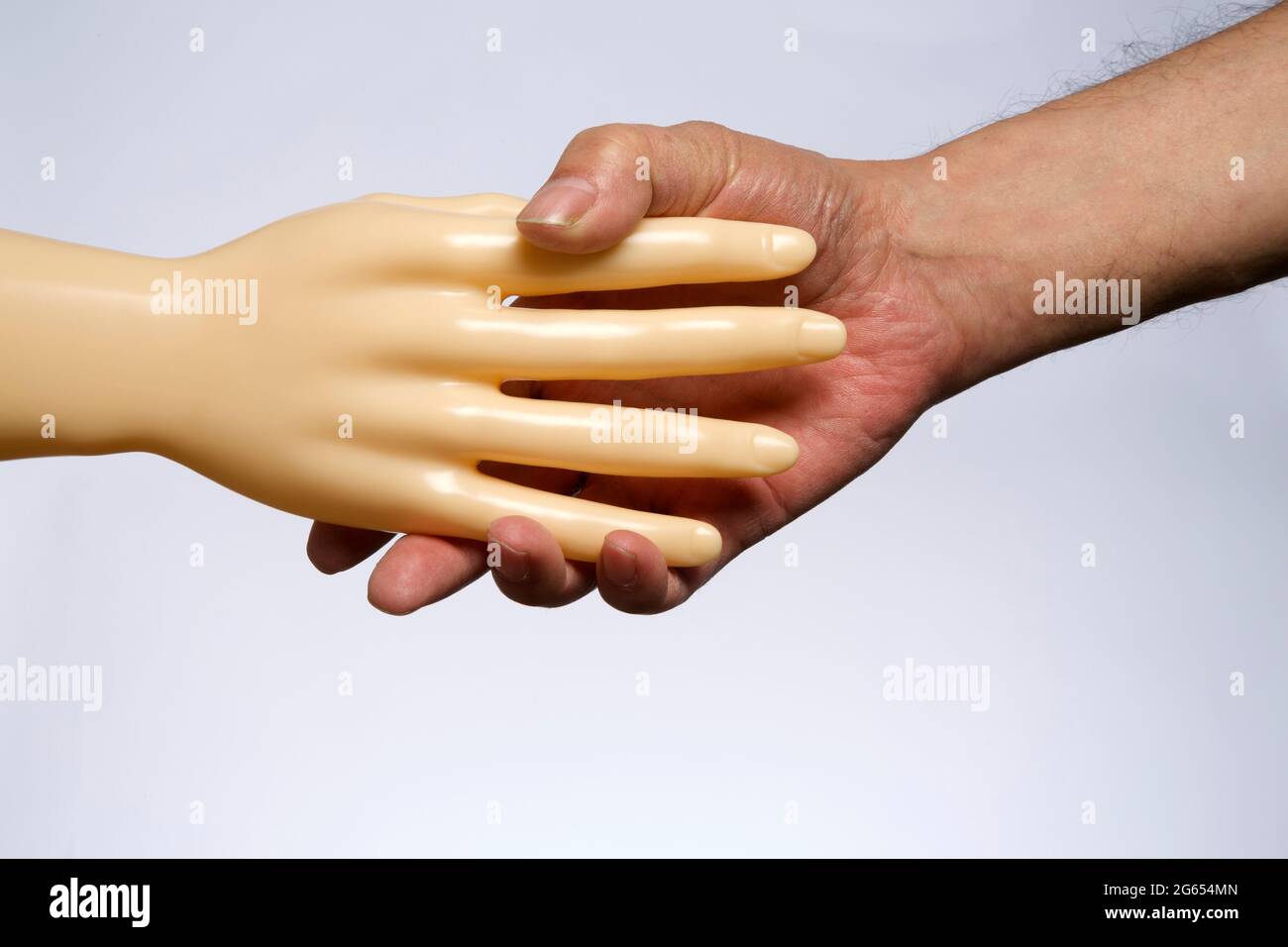 Human hand shaking artificial hand Stock Photo - Alamy