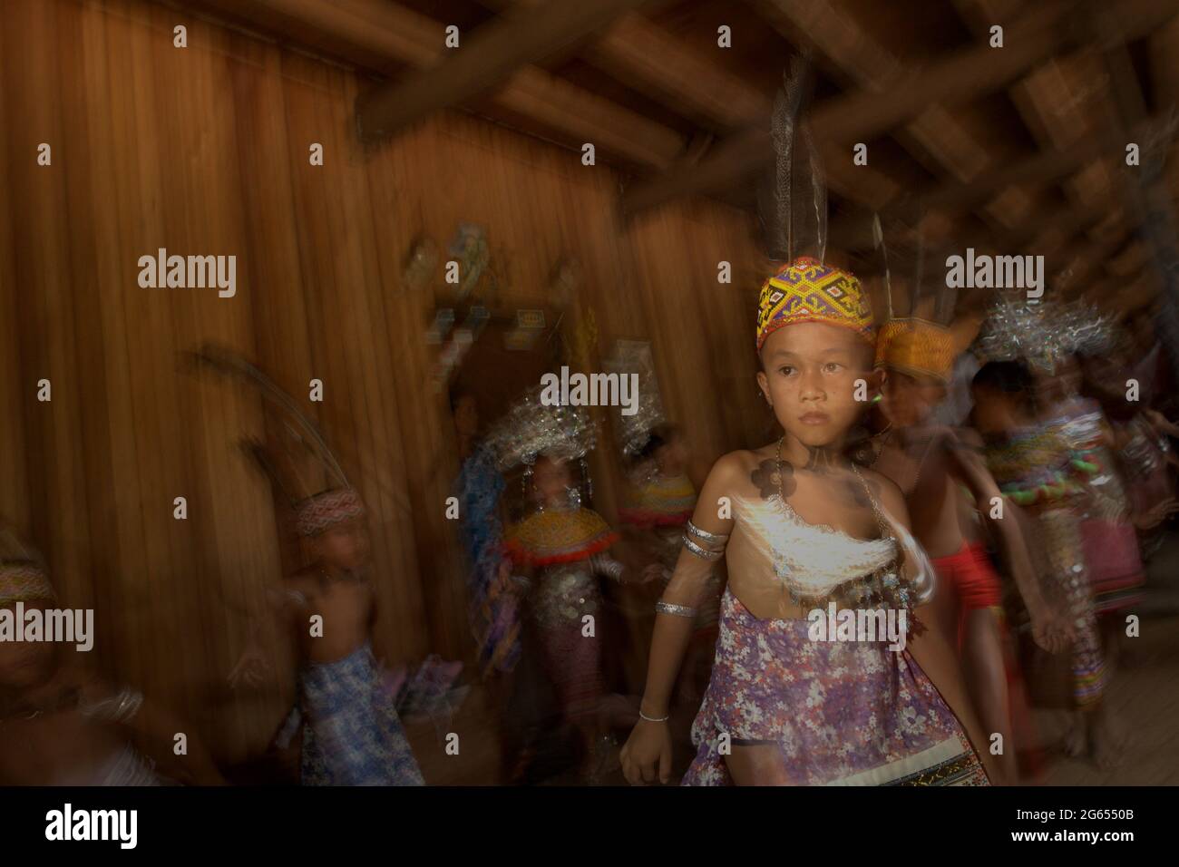 Children performing traditional welcome dance inside the longhouse of ...