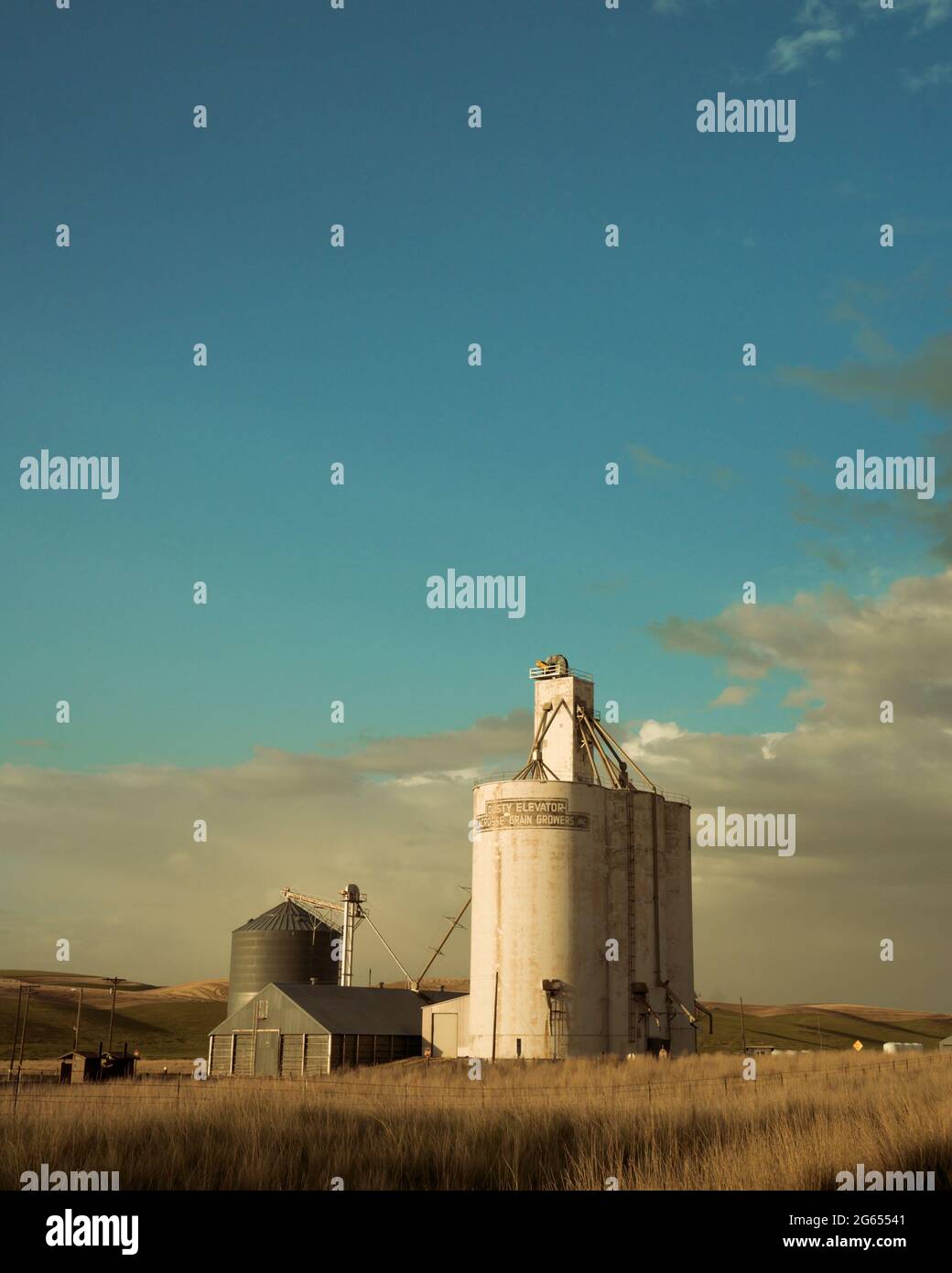 View of industrial grain elevator seen from wheat farm in the Palouse ...