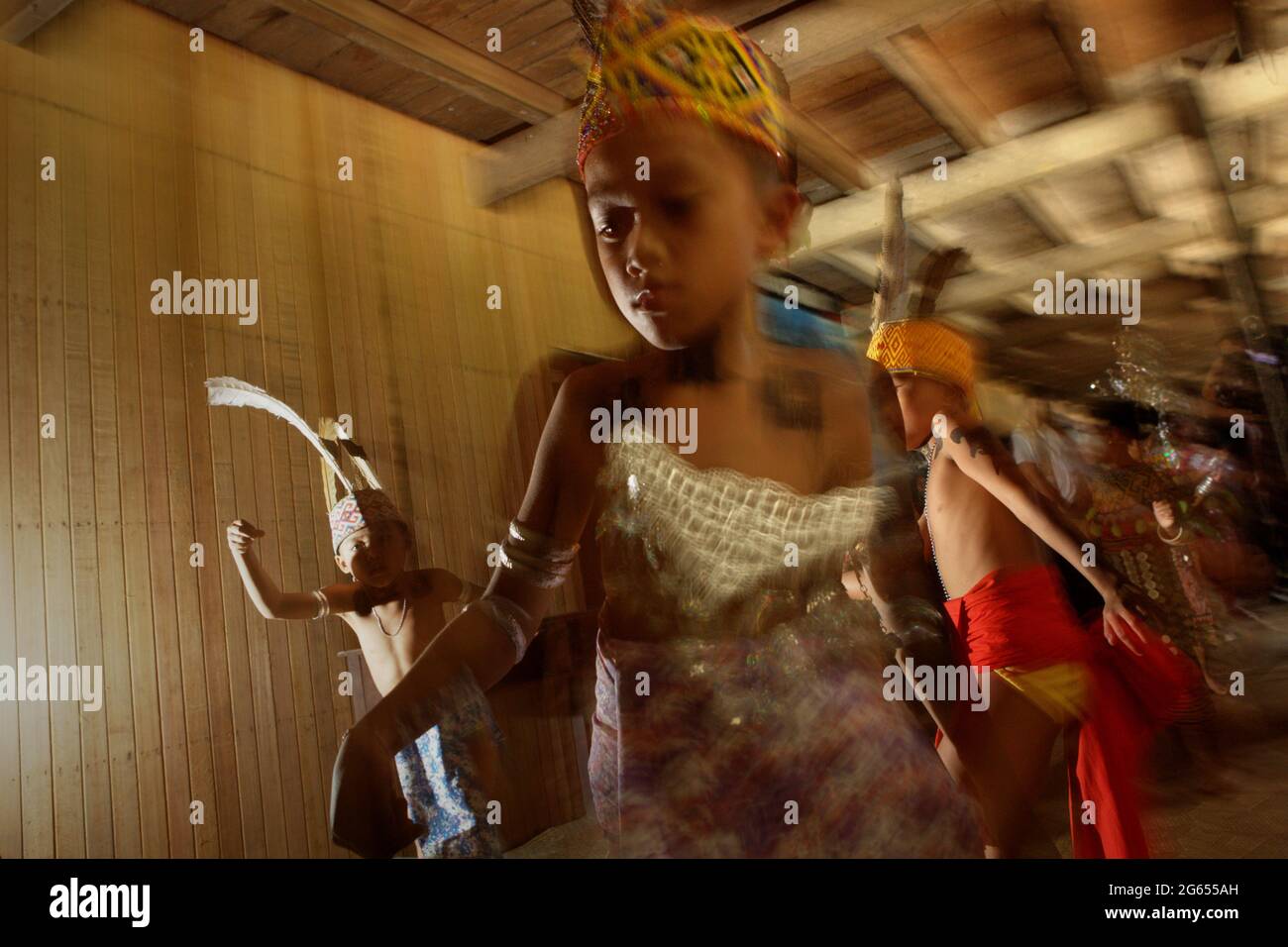 Children performing traditional welcome dance inside the longhouse of ...