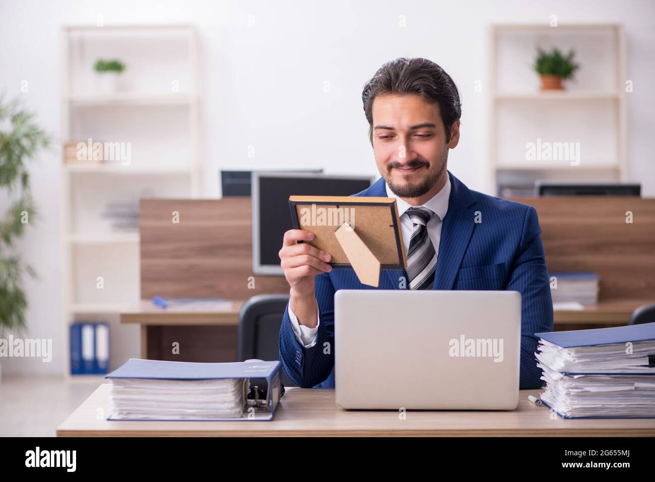 Young employee missing girlfriend at workplace Stock Photo - Alamy