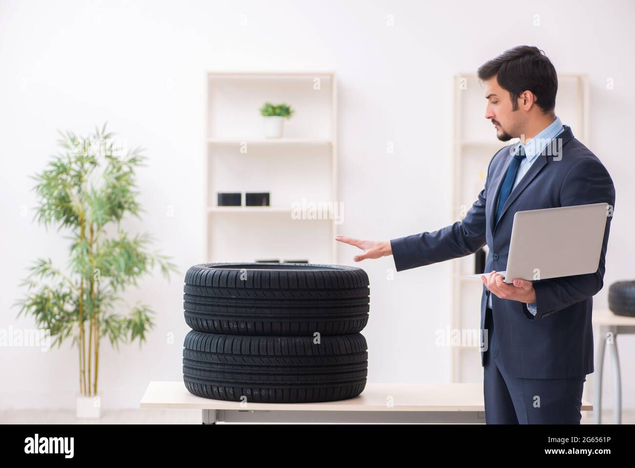 Young businessman selling tires in the office Stock Photo - Alamy