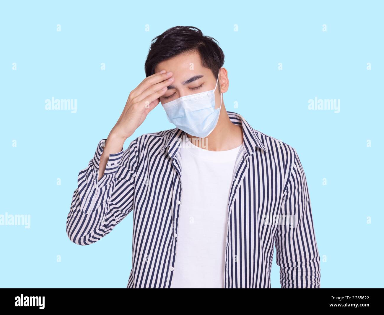 young man feel uncomfortable touching his head and wearing a protective ...