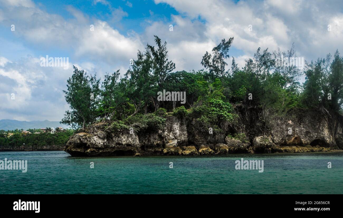 Rock Island over crystal clear sea water Stock Photo - Alamy