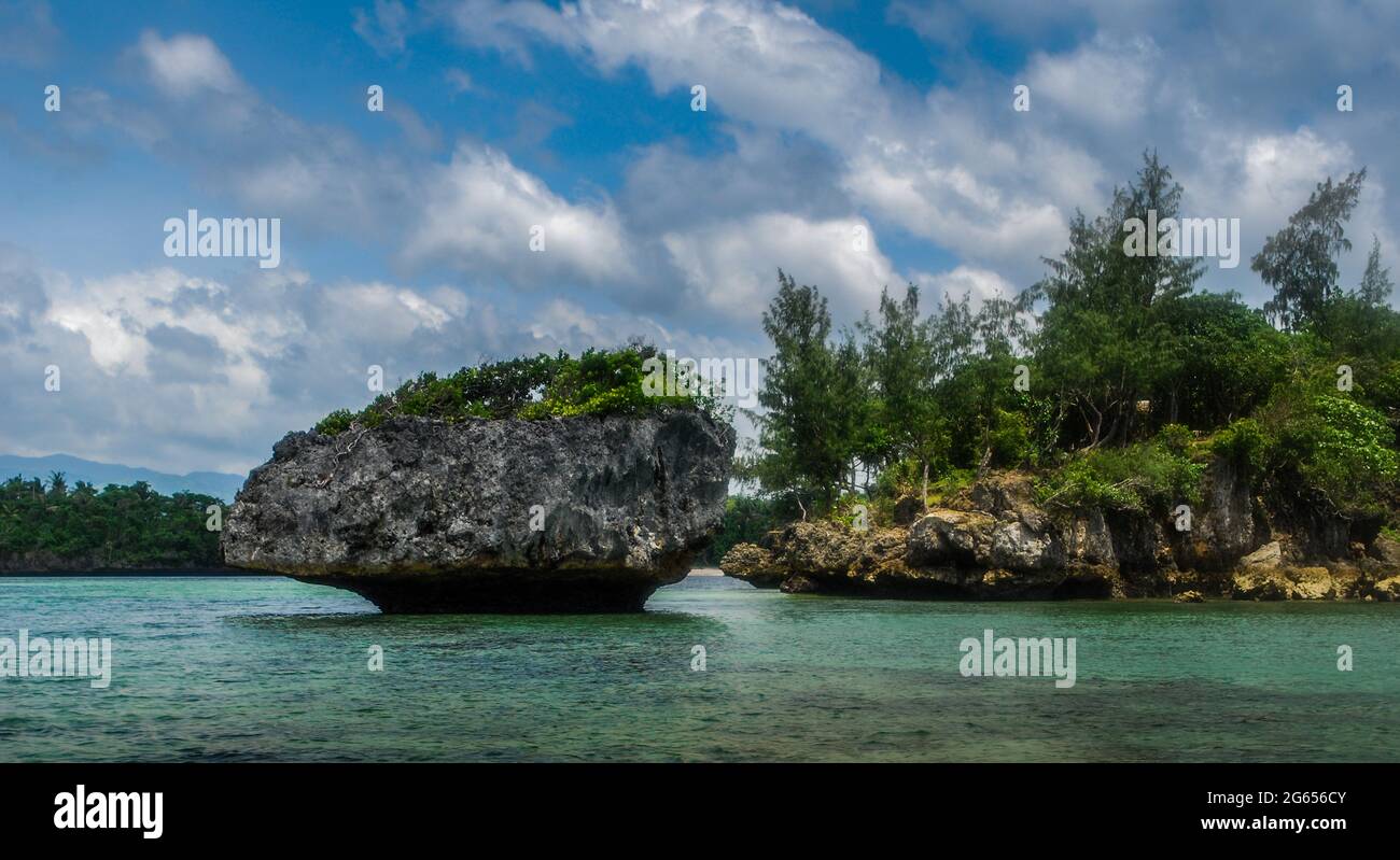 Rock Island over crystal clear sea water Stock Photo - Alamy