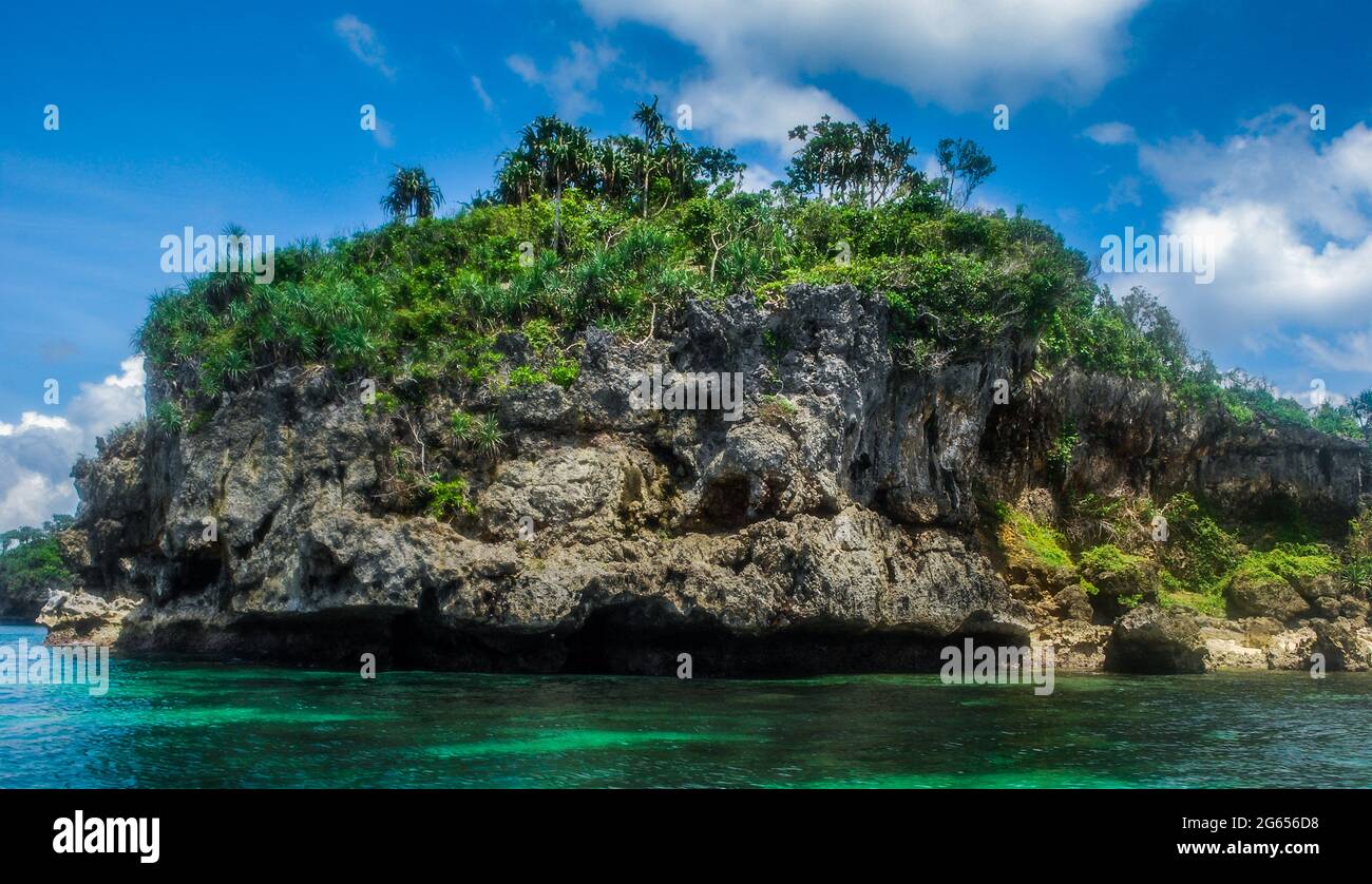 Rock Island over crystal clear sea water Stock Photo - Alamy