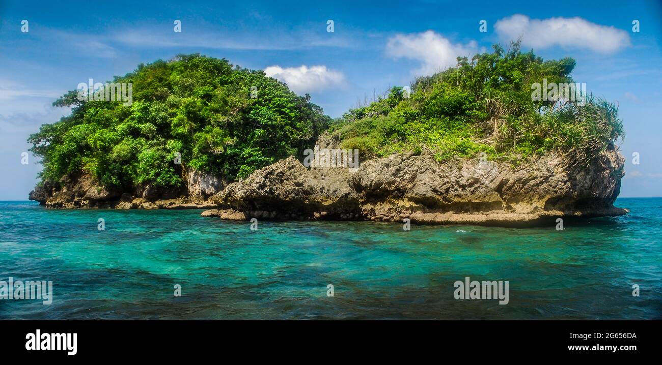 Rock Island over crystal clear sea water Stock Photo - Alamy