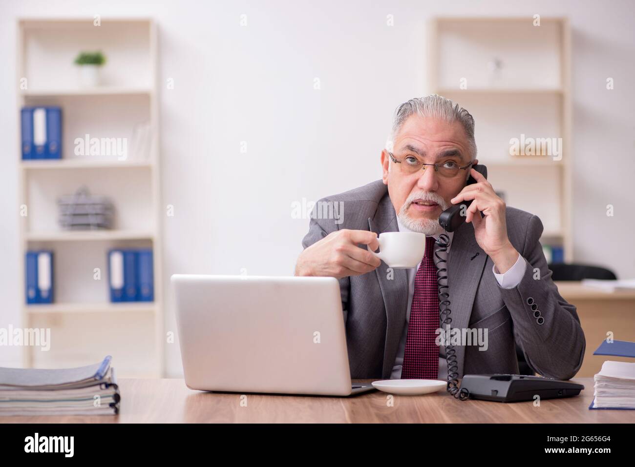 Old businessman employee drinking tea during break Stock Photo - Alamy