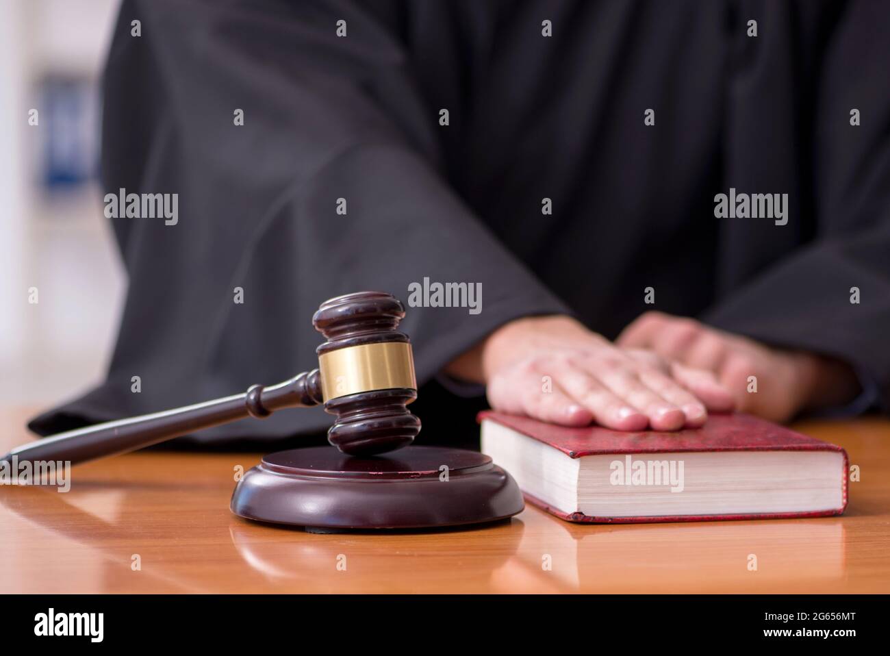 Young judge working in the courtroom Stock Photo - Alamy