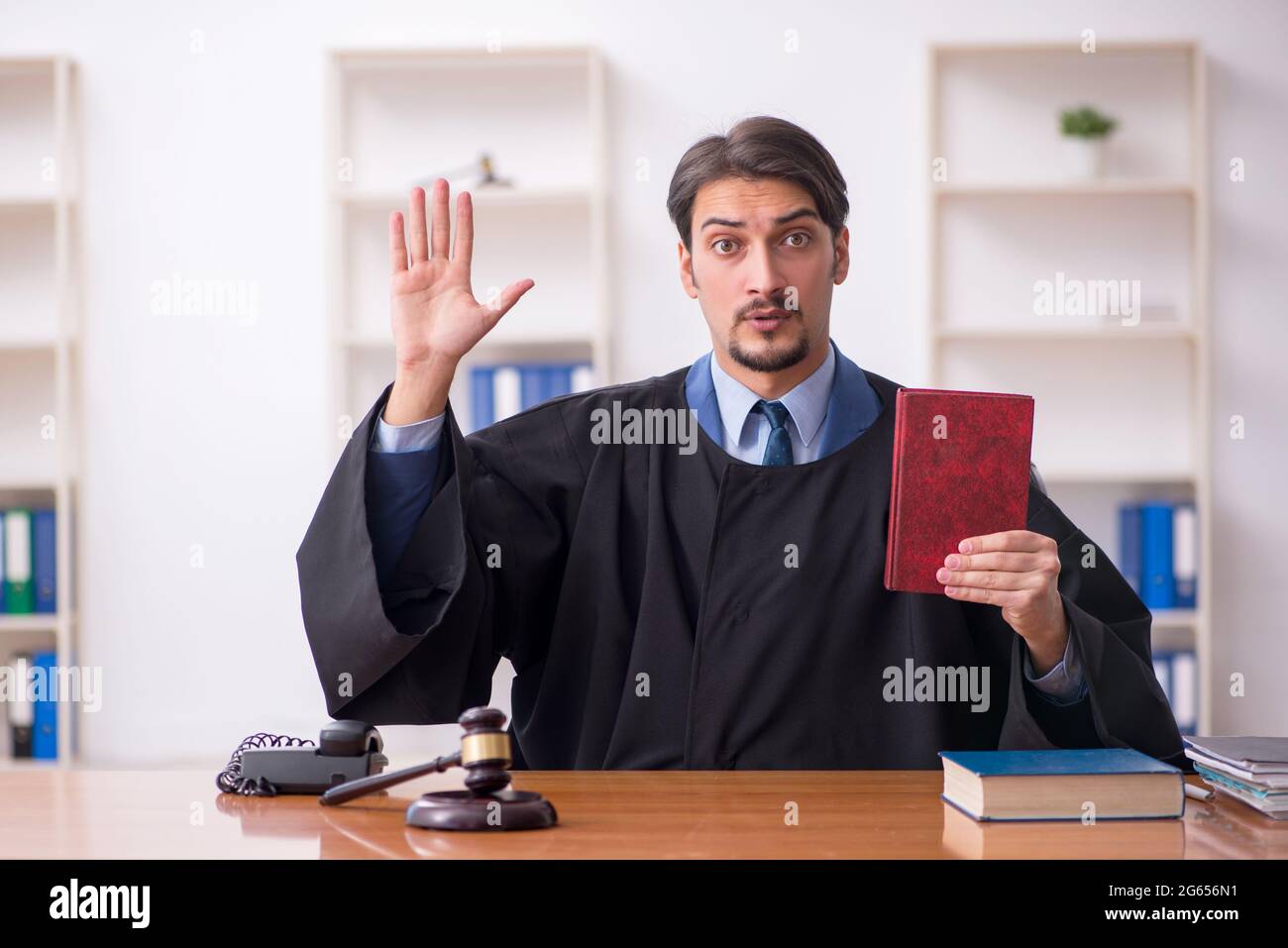 Young judge working in the courtroom Stock Photo - Alamy