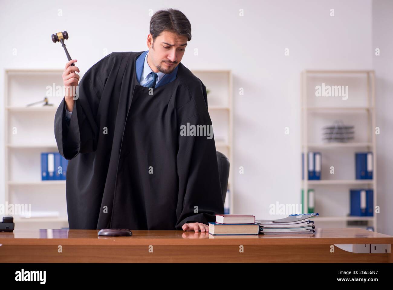 Young judge knocking gavel hi-res stock photography and images - Alamy