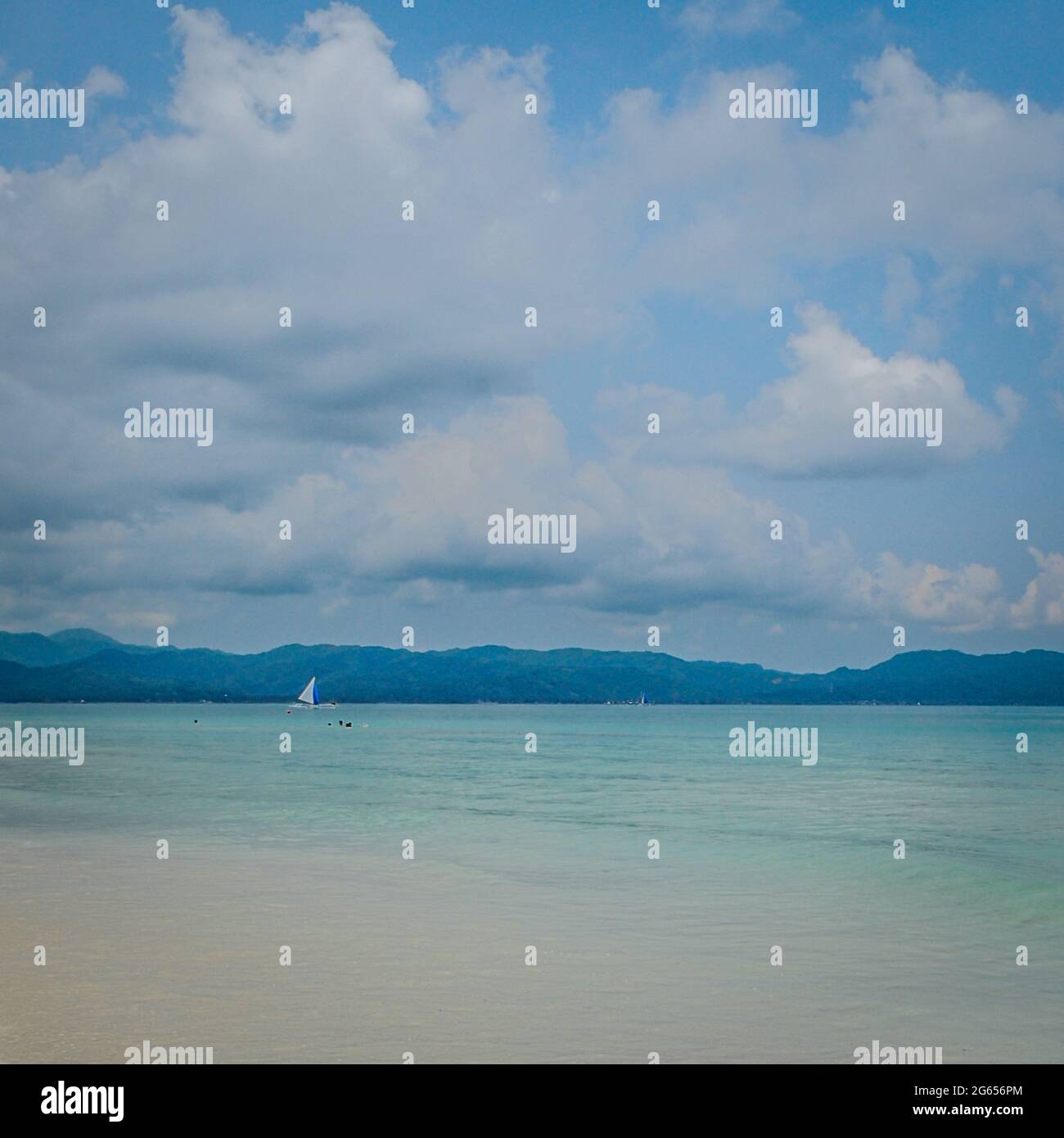 Blue sea under not so cloudy summer sky Stock Photo - Alamy