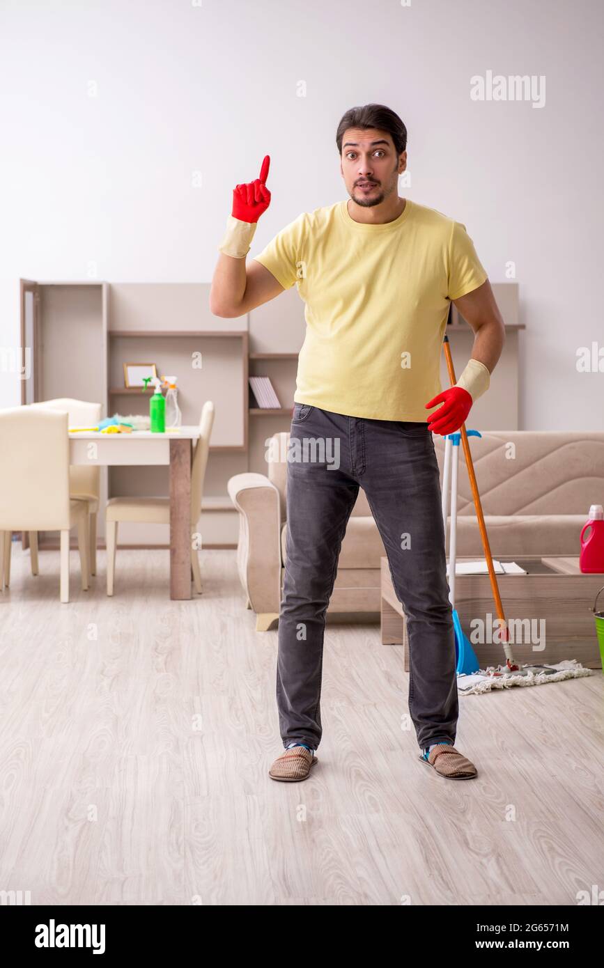 Young male cleaner cleaning the house Stock Photo - Alamy