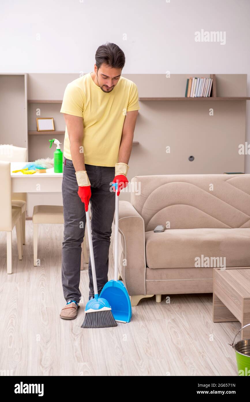 Young male cleaner cleaning the house Stock Photo - Alamy