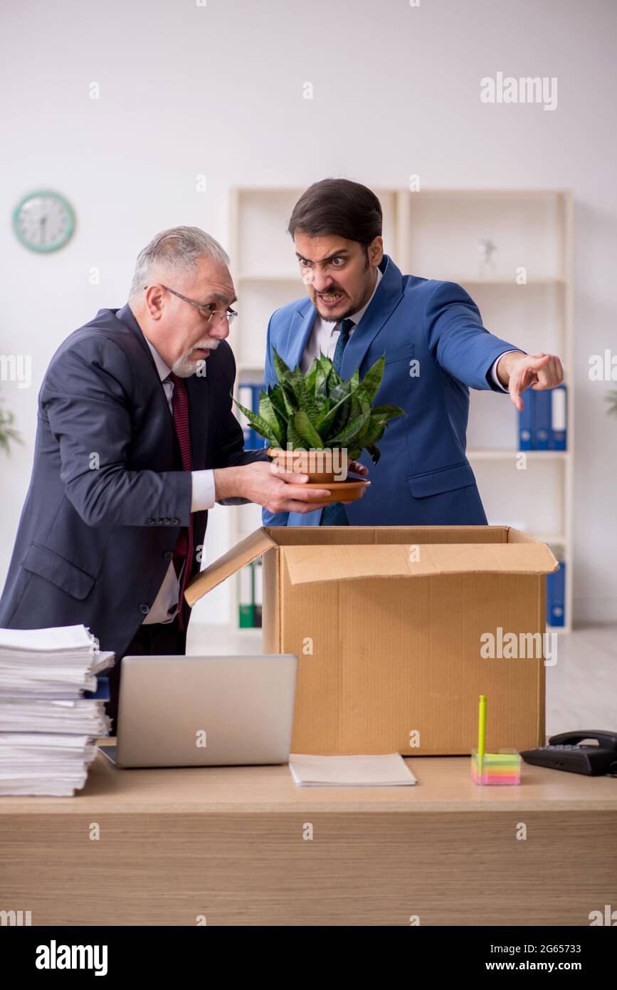 Two employees in dismissal concept Stock Photo - Alamy