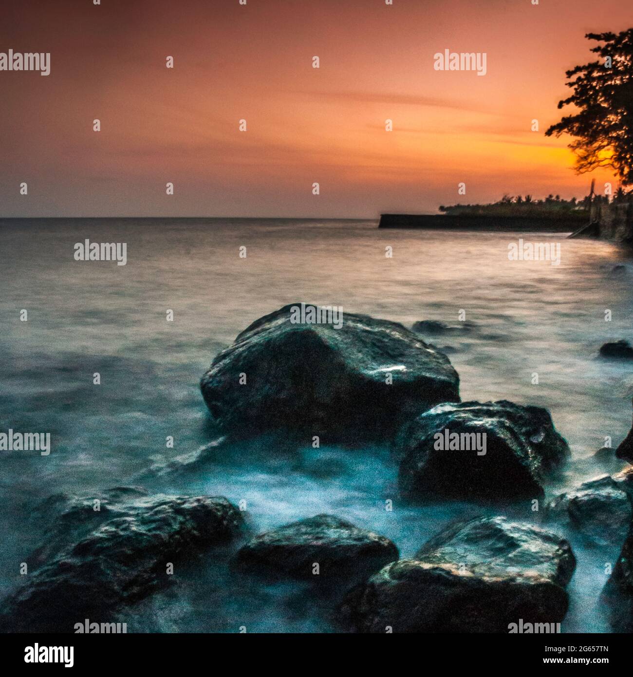 Rocks and flowing waves Stock Photo - Alamy