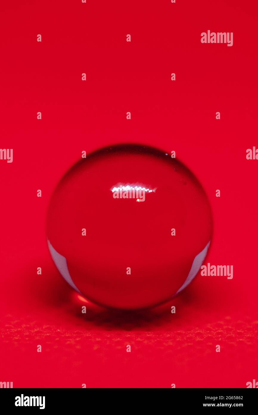 Red crystal ball isolated on a red background with free space for text ...