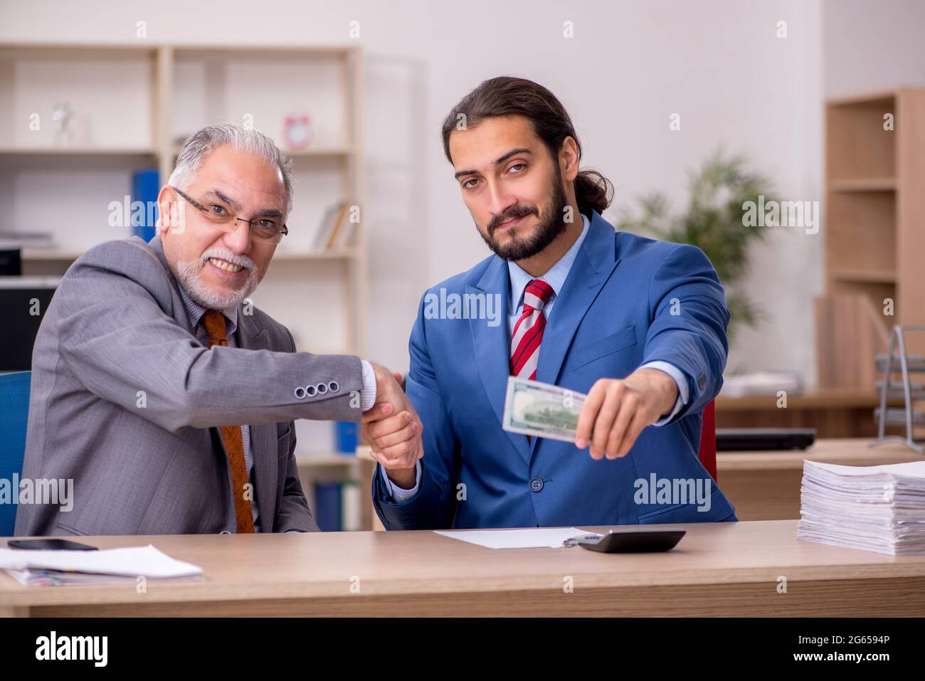 Two employees in remuneration concept Stock Photo - Alamy