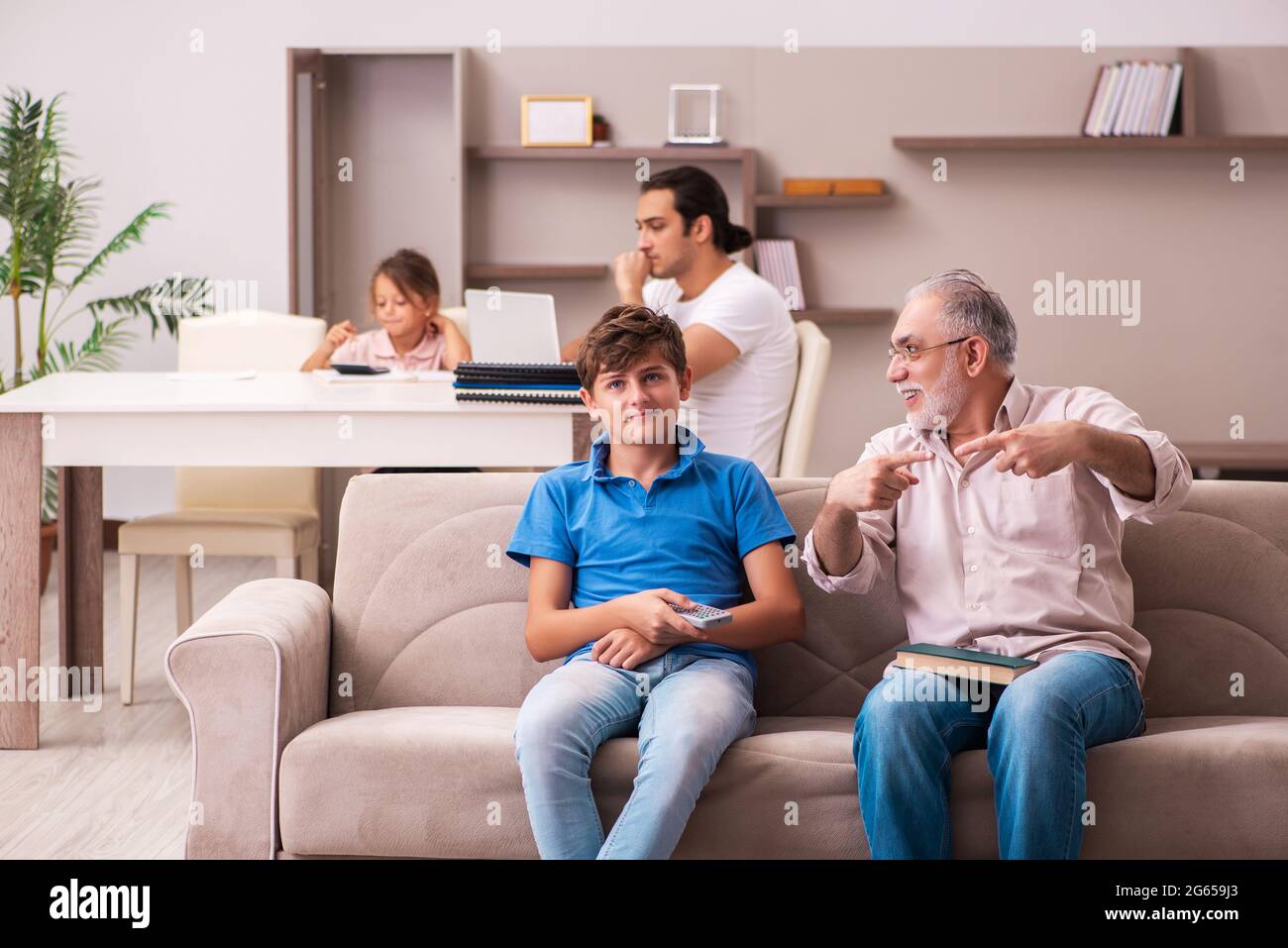Three generations family watching tv hi-res stock photography and ...