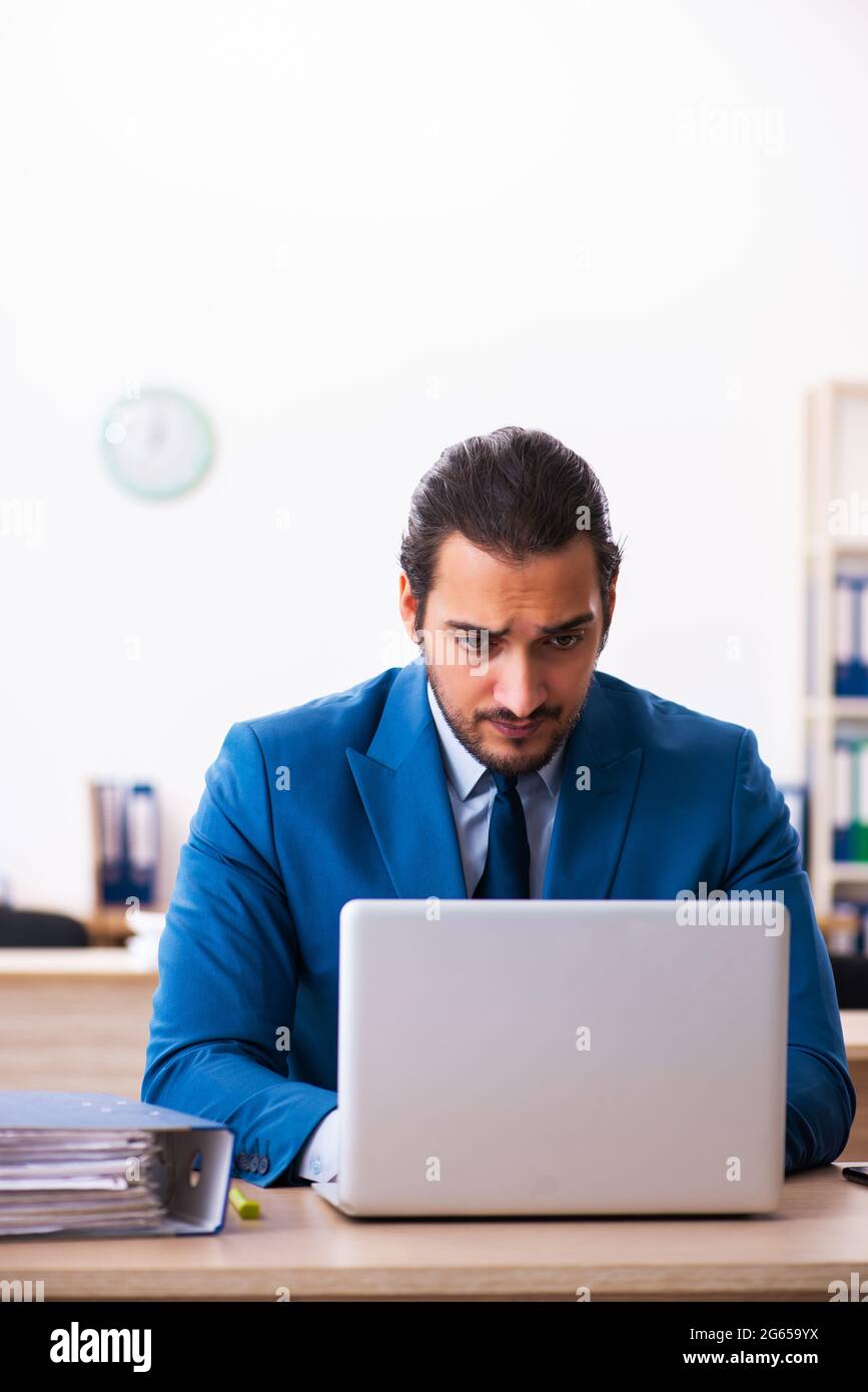 Young employee and too many work in the office Stock Photo - Alamy