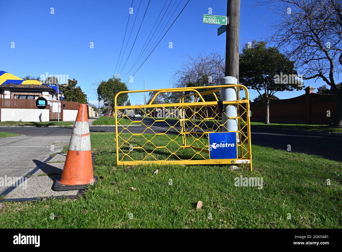 A damaged Telstra communication pillar, next to Telstra cable pits ...