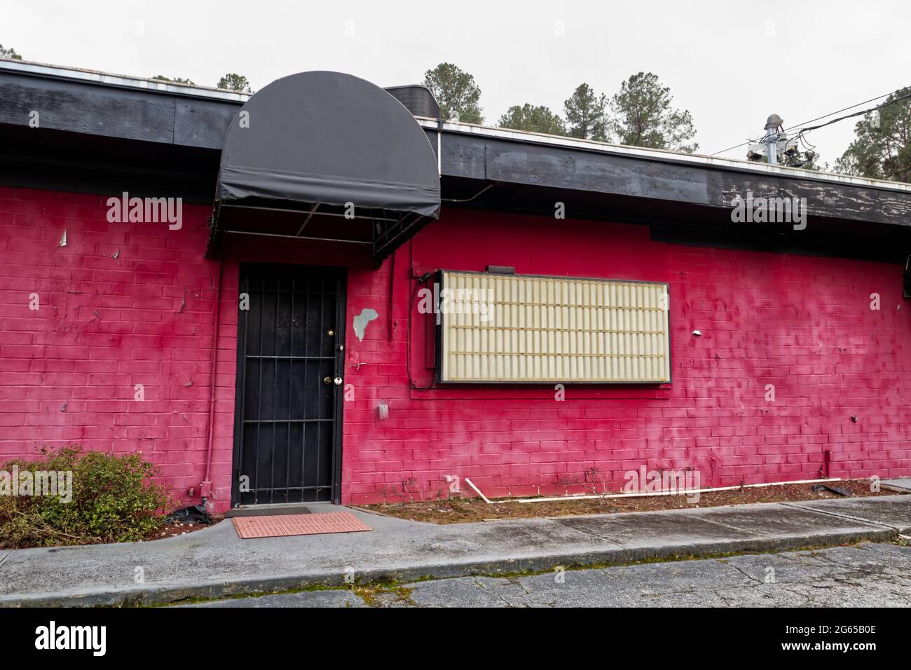 closed urban club with bars on the door and blank sign Stock Photo - Alamy