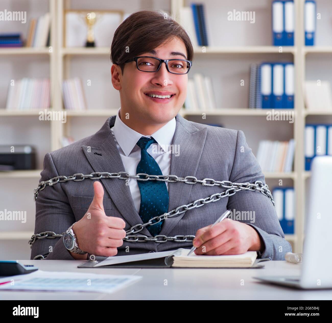 The businessman tied with chains to his work Stock Photo - Alamy