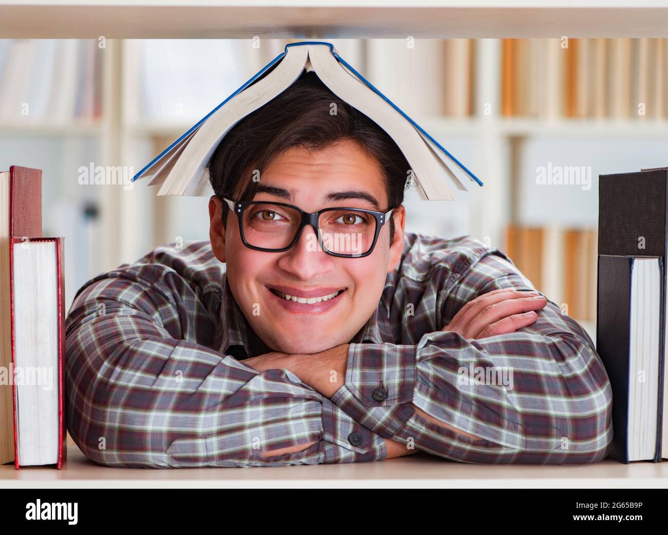The young student looking for books in college library Stock Photo - Alamy