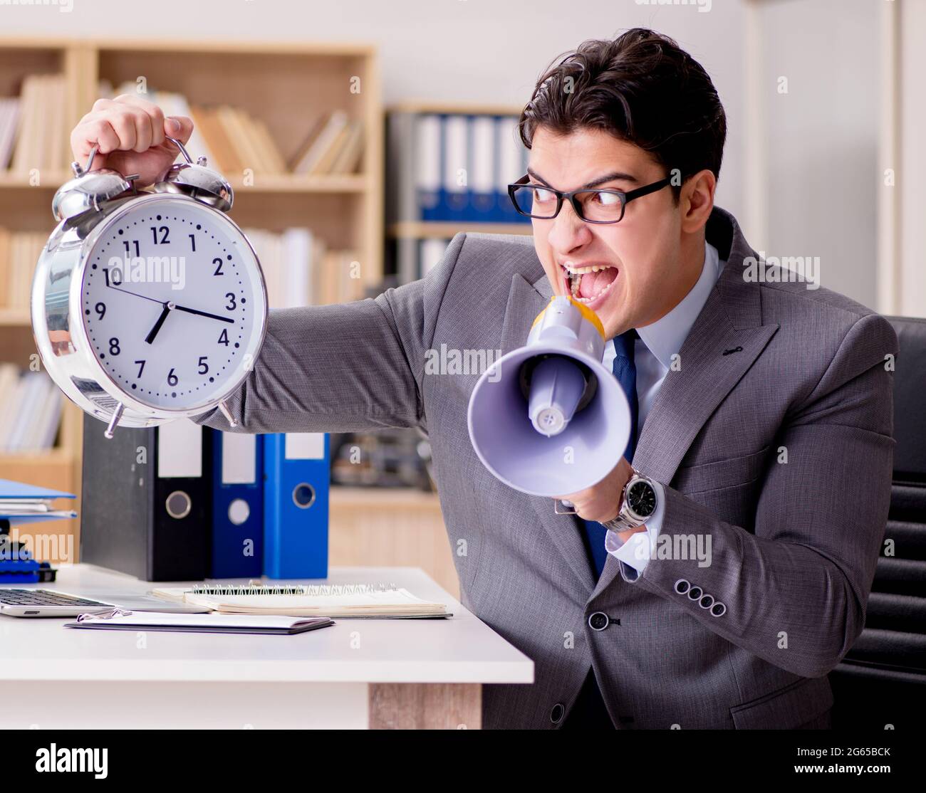 The businessman with loudspeaker megaphone in office Stock Photo - Alamy