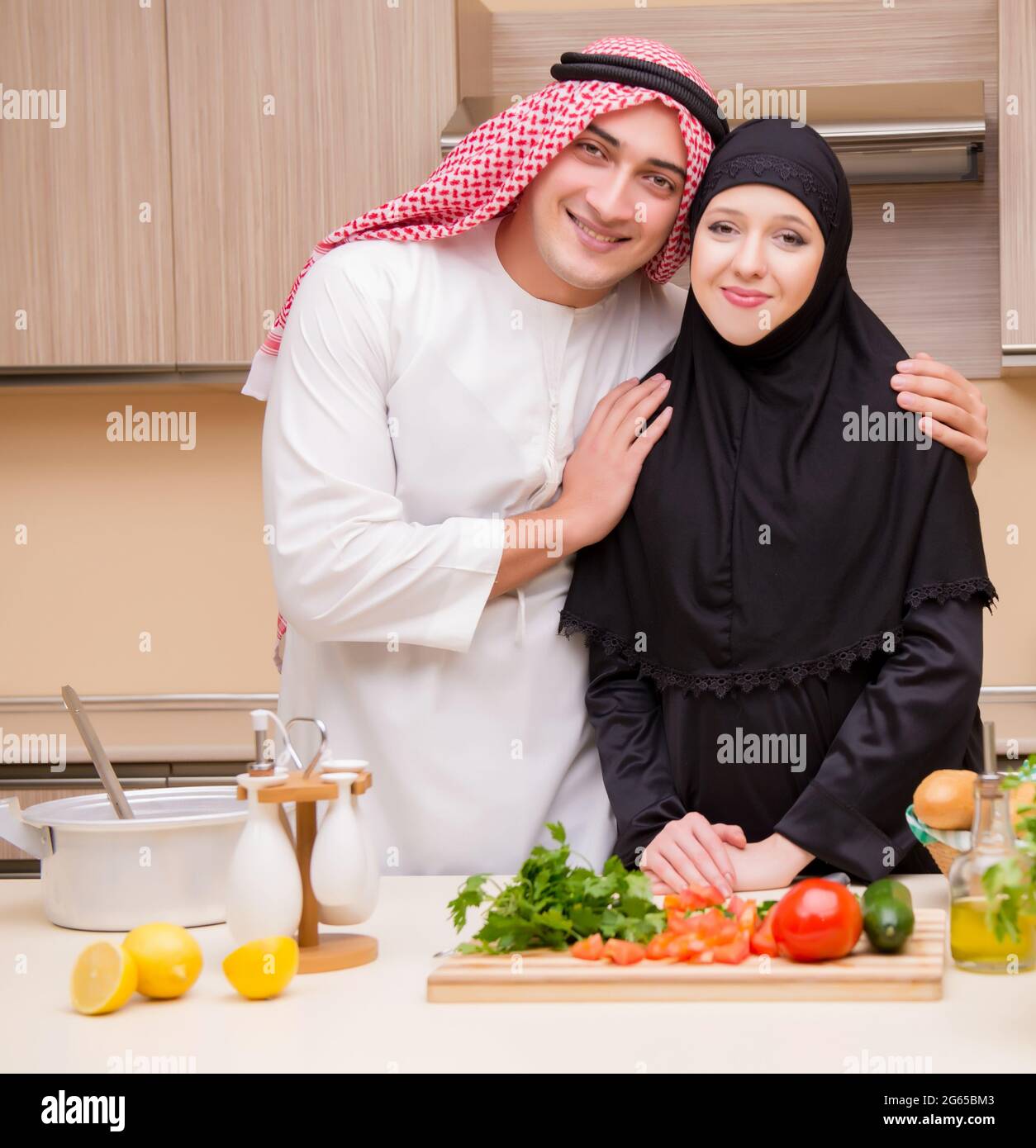 The young arab family in the kitchen Stock Photo - Alamy