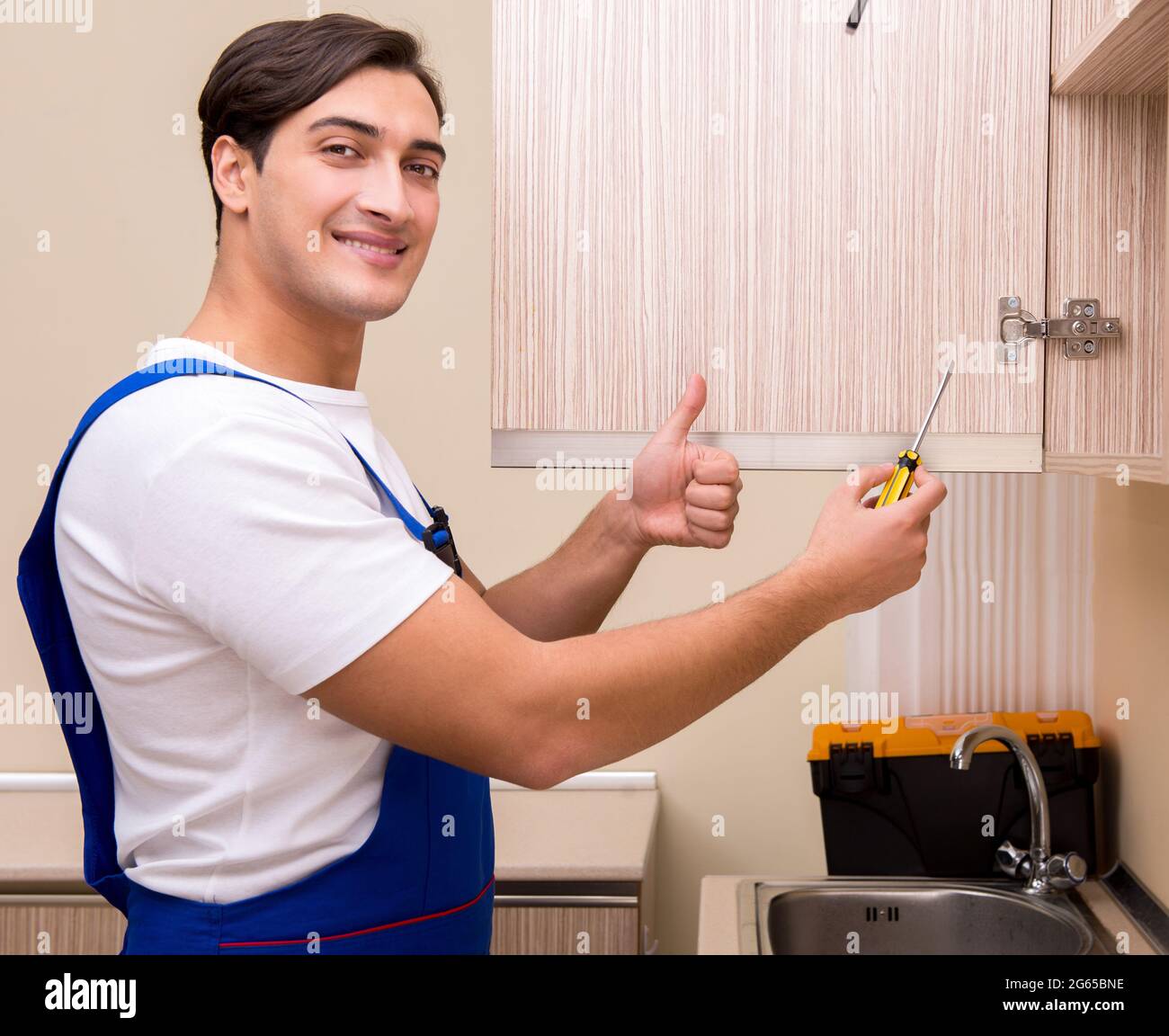 Young repairman assembling new table hi-res stock photography and ...