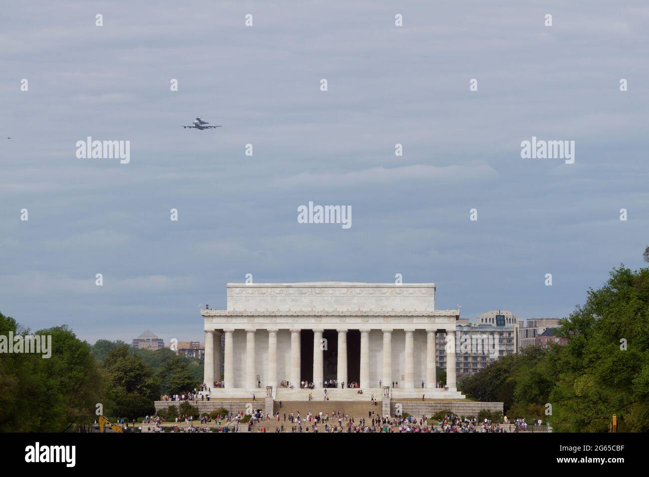 The space shuttle Discovery flies over the Lincoln Memorial during its ...