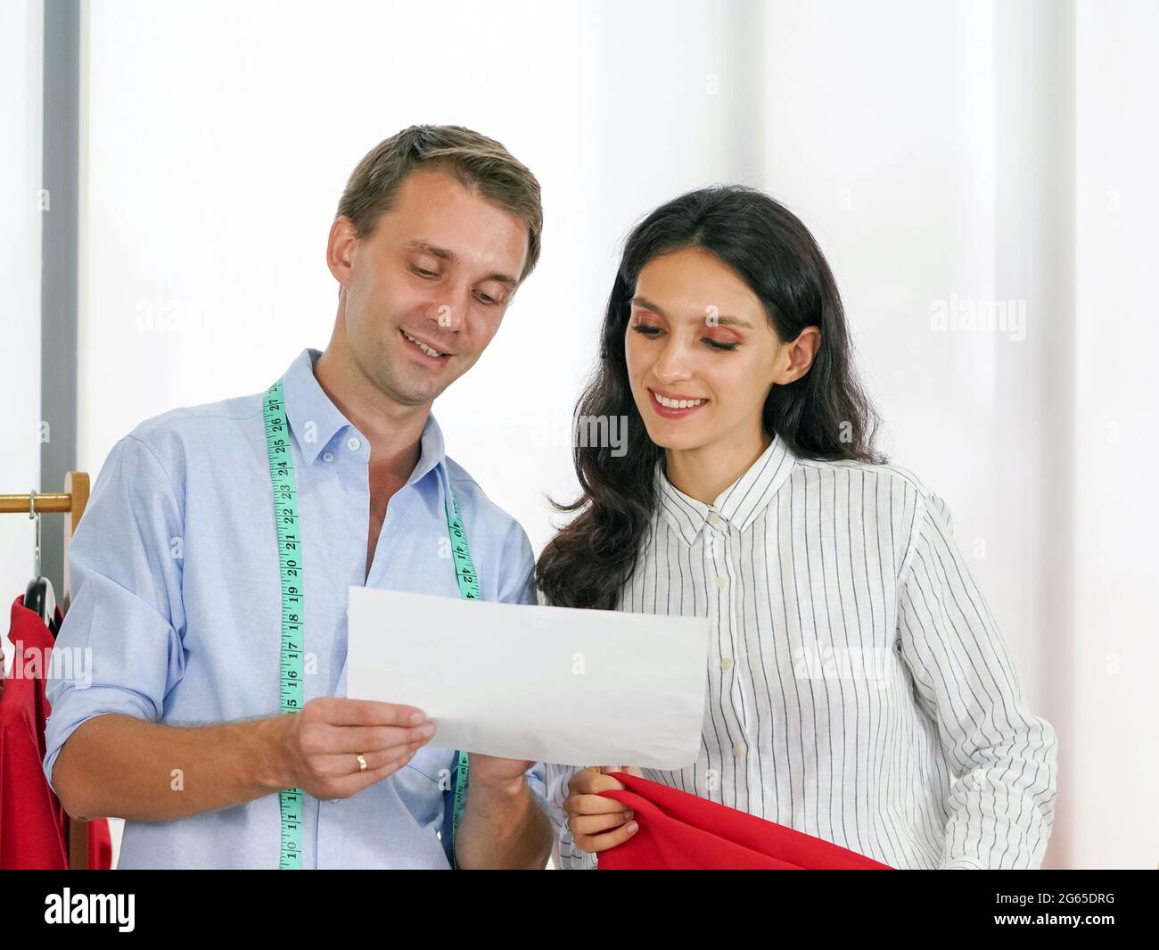 Fashion designer room, man and woman working in home base cloth design ...