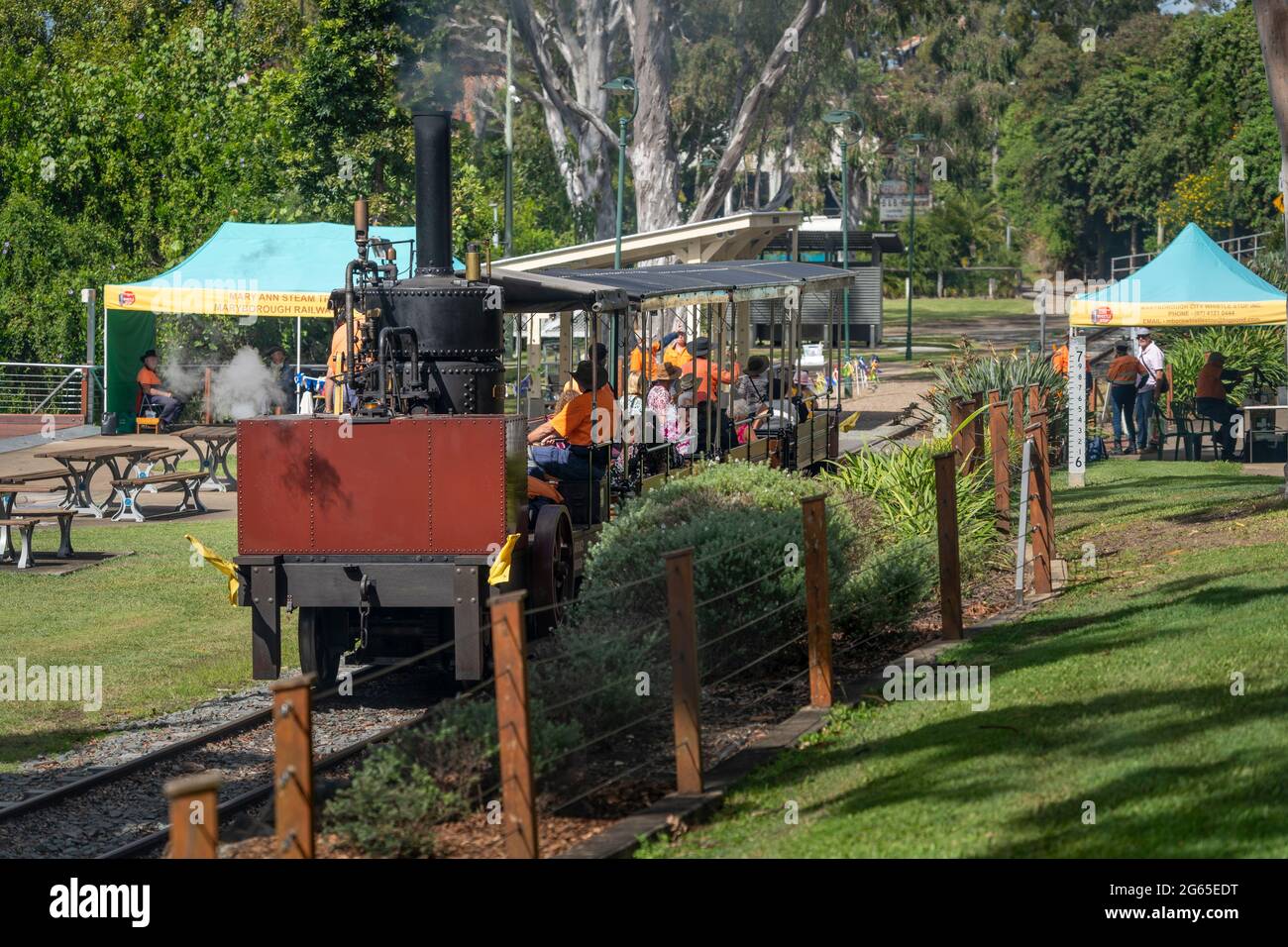 Tourists riding on the Mary Ann replica steam locomotive in Maryborough ...