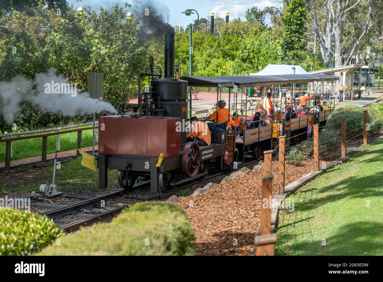 Tourists riding on the Mary Ann replica steam locomotive in Maryborough ...